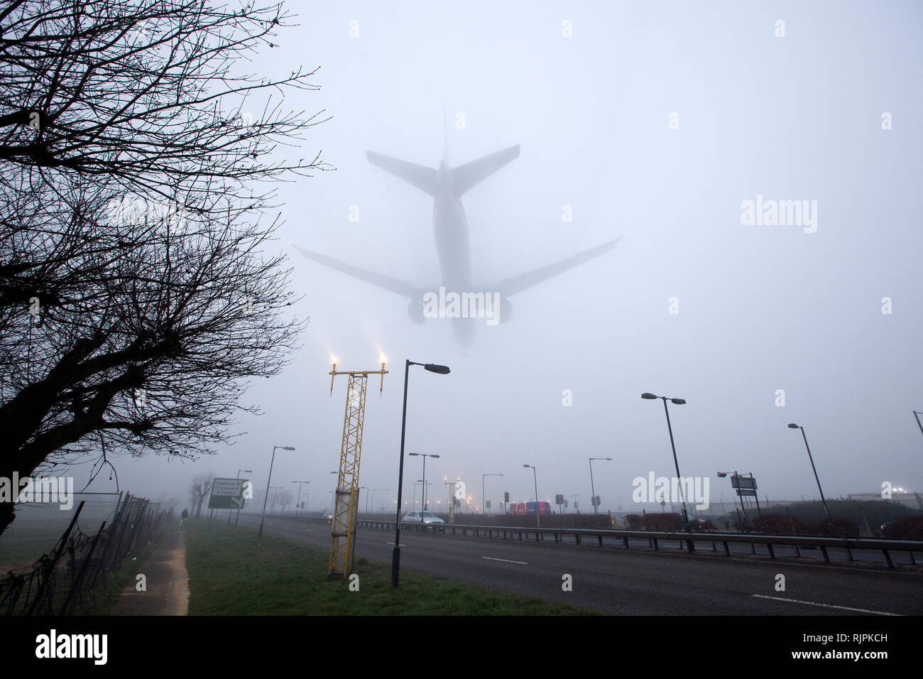 An aircraft lands at London Heathrow airport in heavy fog on March 13 ...