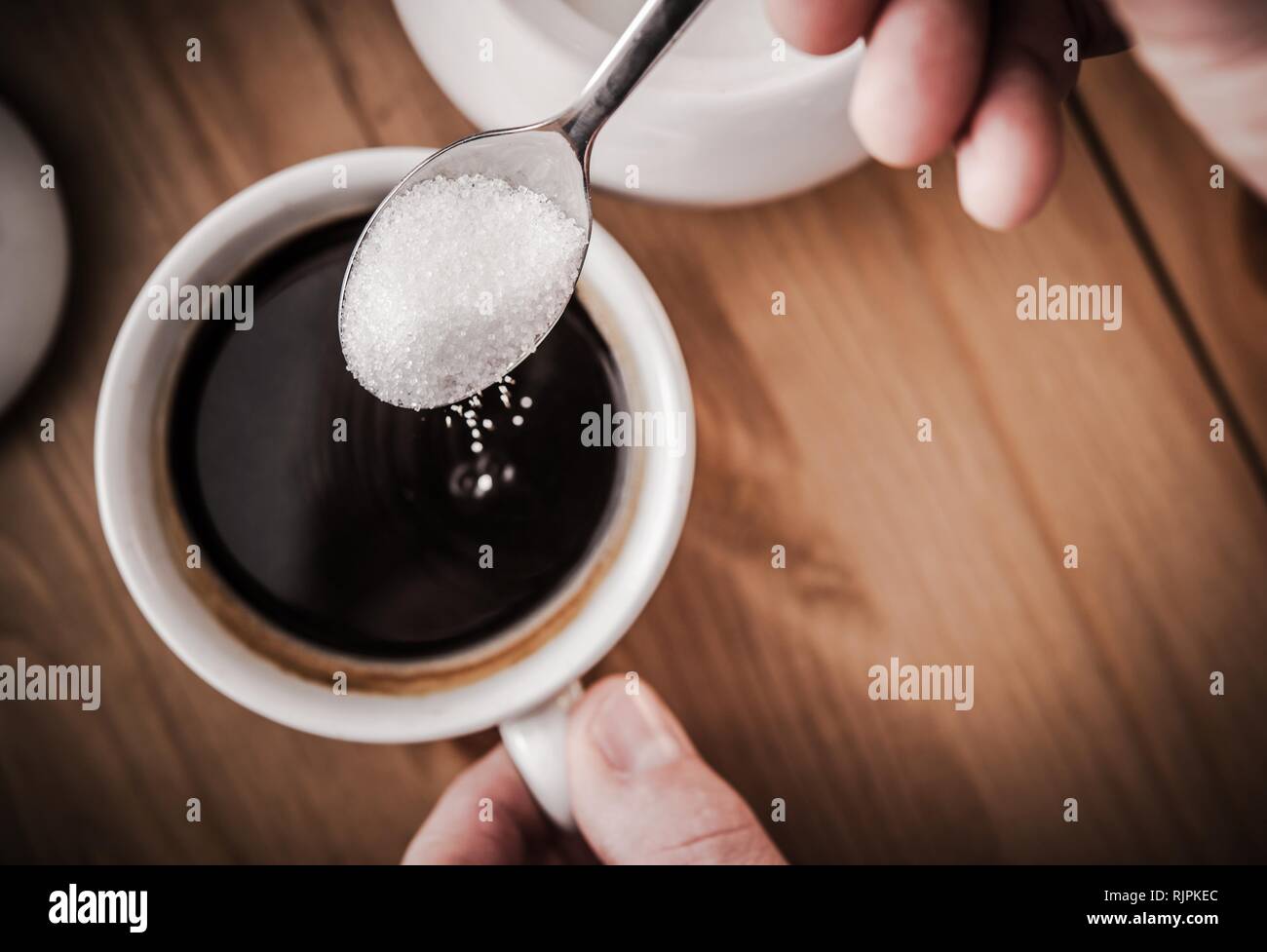Adding Sugar to Cup of Black Coffee. Sweetening Using Cane Sugar Stock ...