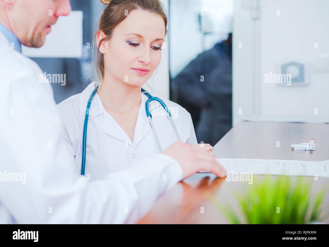 Caucasian Female Medical Worker in White Lab Coat Making Conversation ...