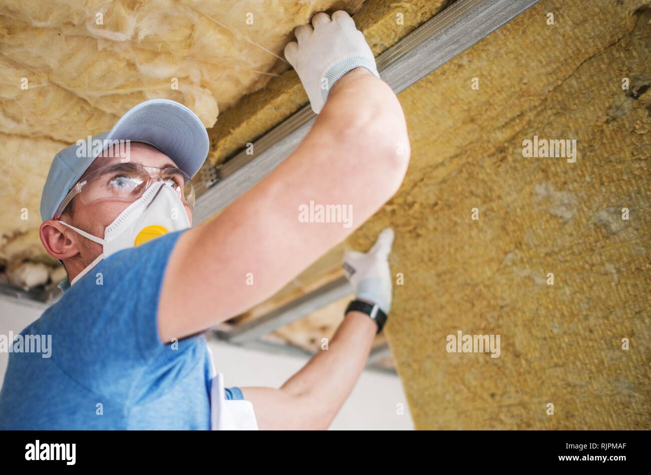 Mineral Insulation Installer. Caucasian Construction Worker Installing ...