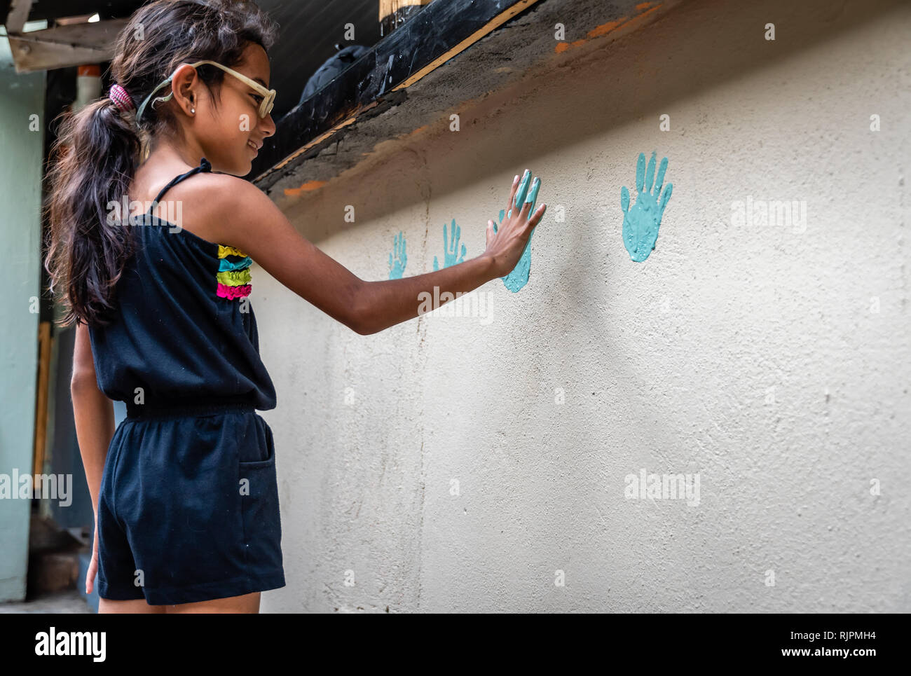 young latin girl making hand prints in Guatemala Stock Photo - Alamy