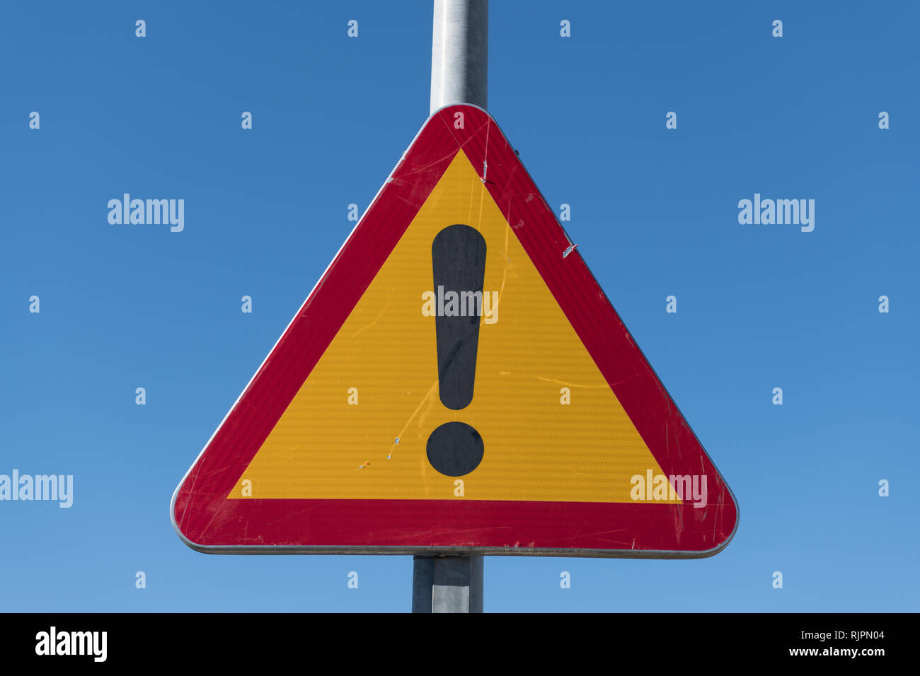 A traffic sign with an exclamation mark of an area under construction ...