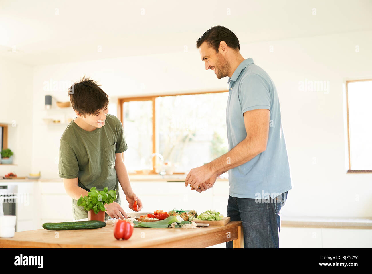 Boy and his father preparing food at kitchen counter Stock Photo - Alamy