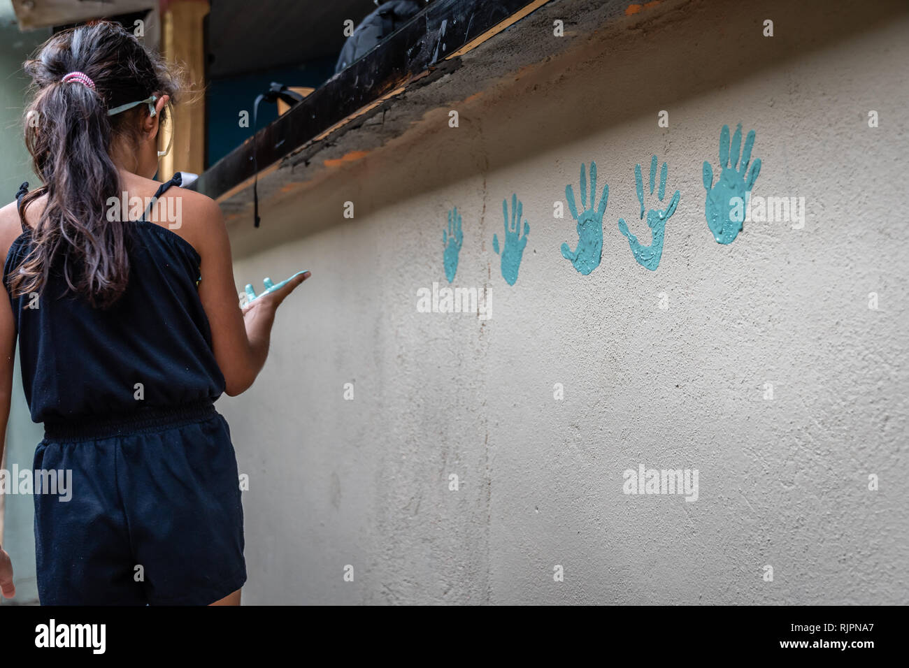 young latin girl making hand prints in Guatemala Stock Photo - Alamy