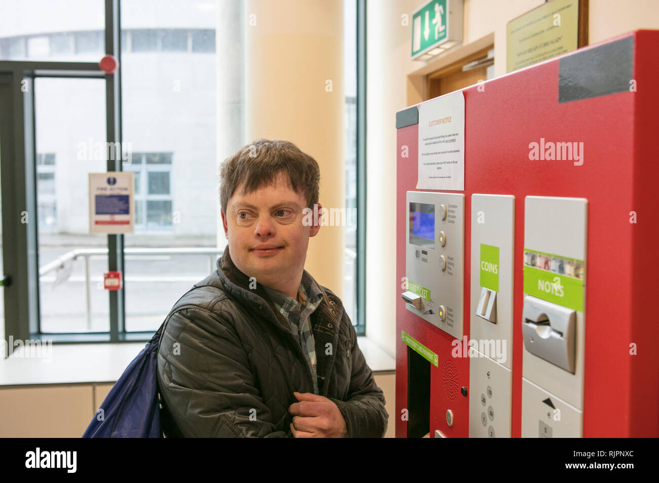Man with down syndrome at ticket machine in train station, Galway ...
