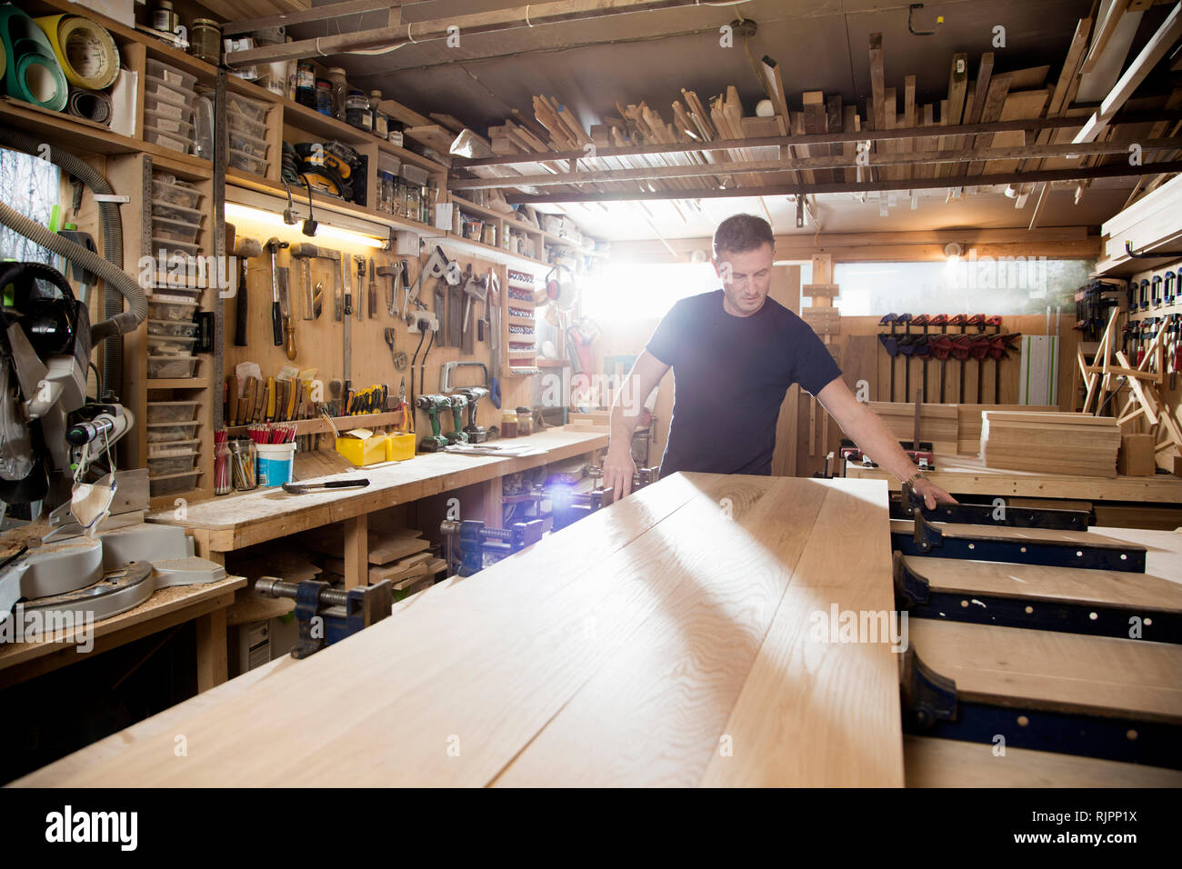 Craftsman preparing planks of wood in workshop Stock Photo - Alamy