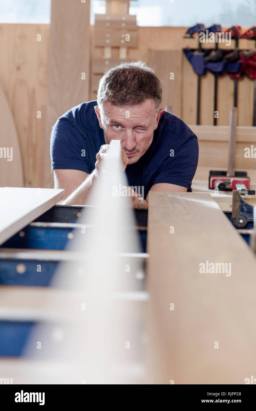 Craftsman preparing planks of wood in workshop Stock Photo - Alamy