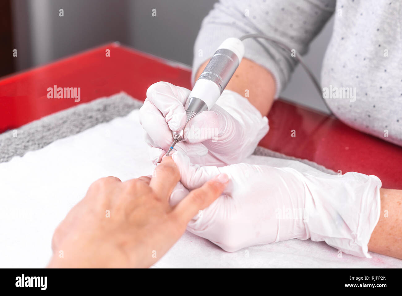 Professional manicure process, cleaning the nails with a manicure ...