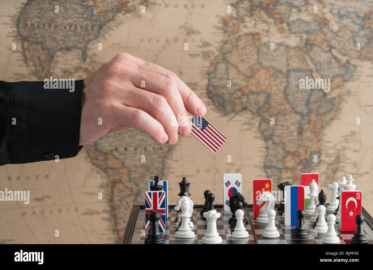 Politician's hand moves a chess piece with a flag. Conceptual photo of ...