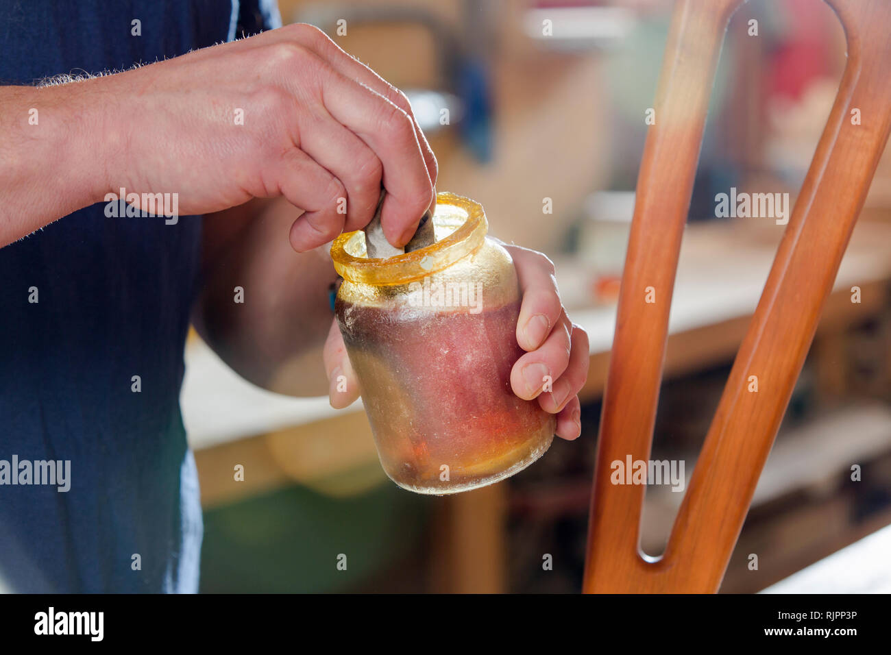 Craftsman polishing wooden stool with oil finish Stock Photo - Alamy