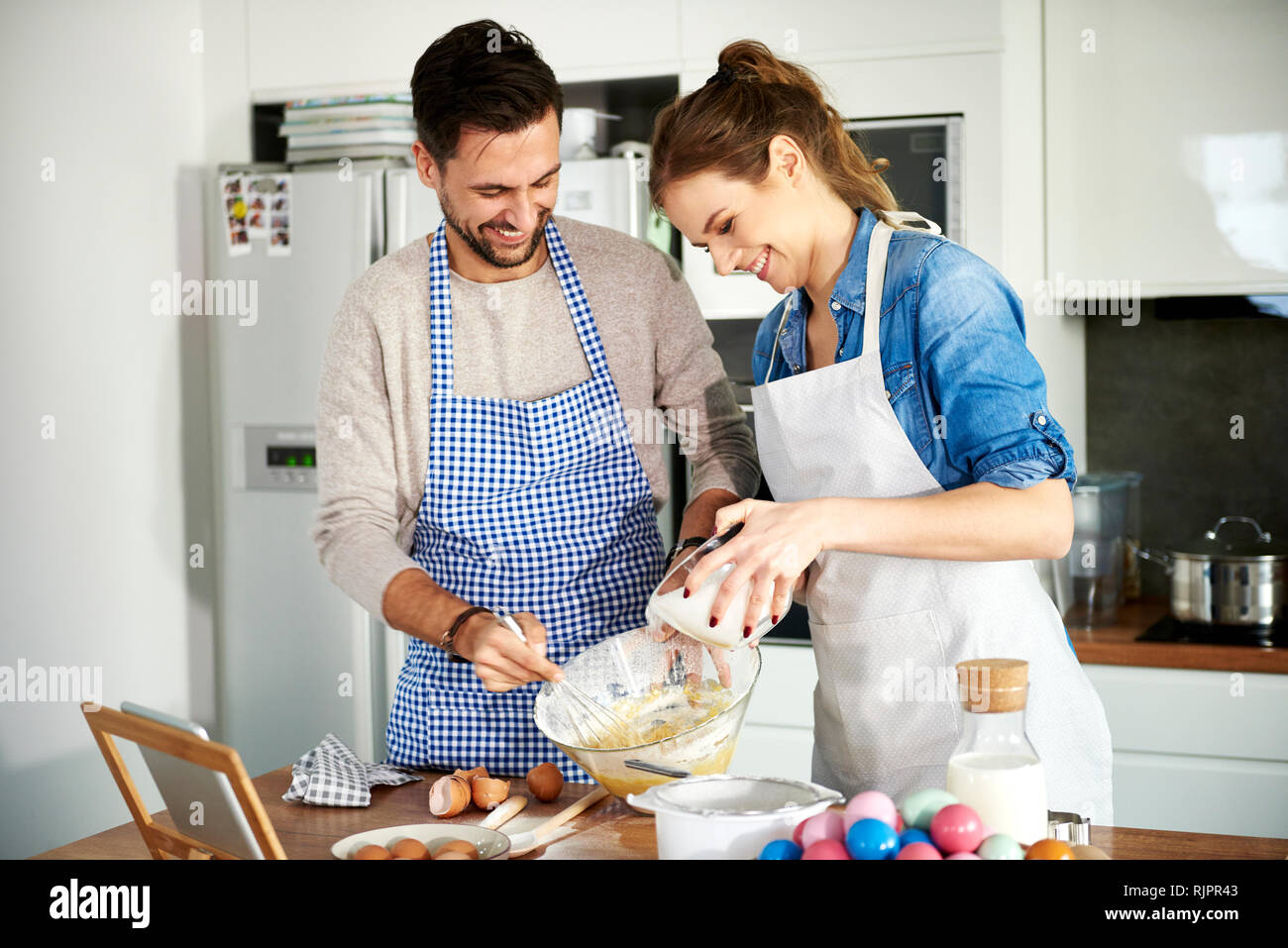Couple baking in kitchen Stock Photo - Alamy