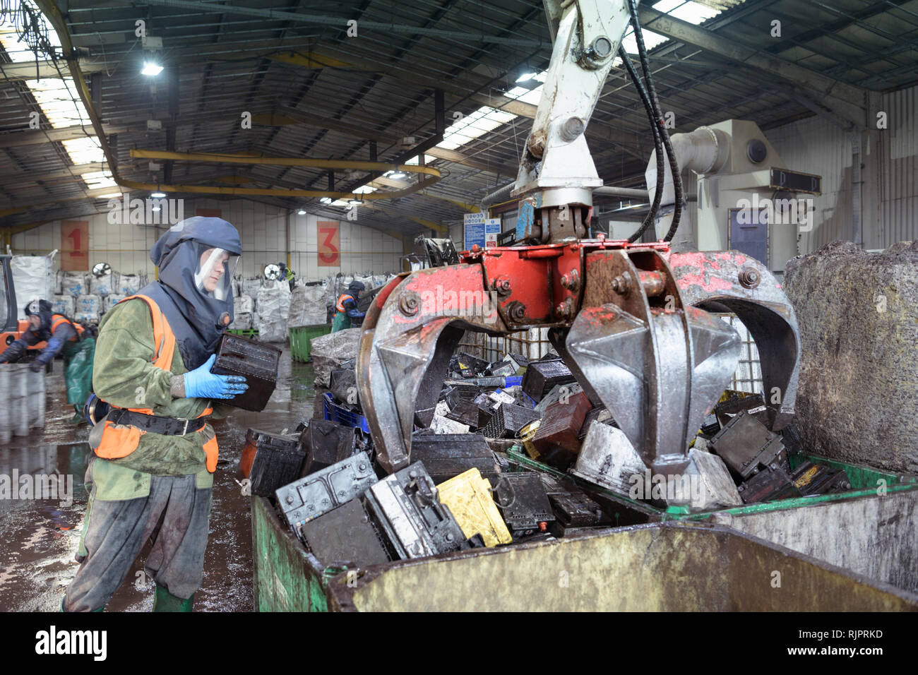 Young person recycling batteries hi-res stock photography and images ...