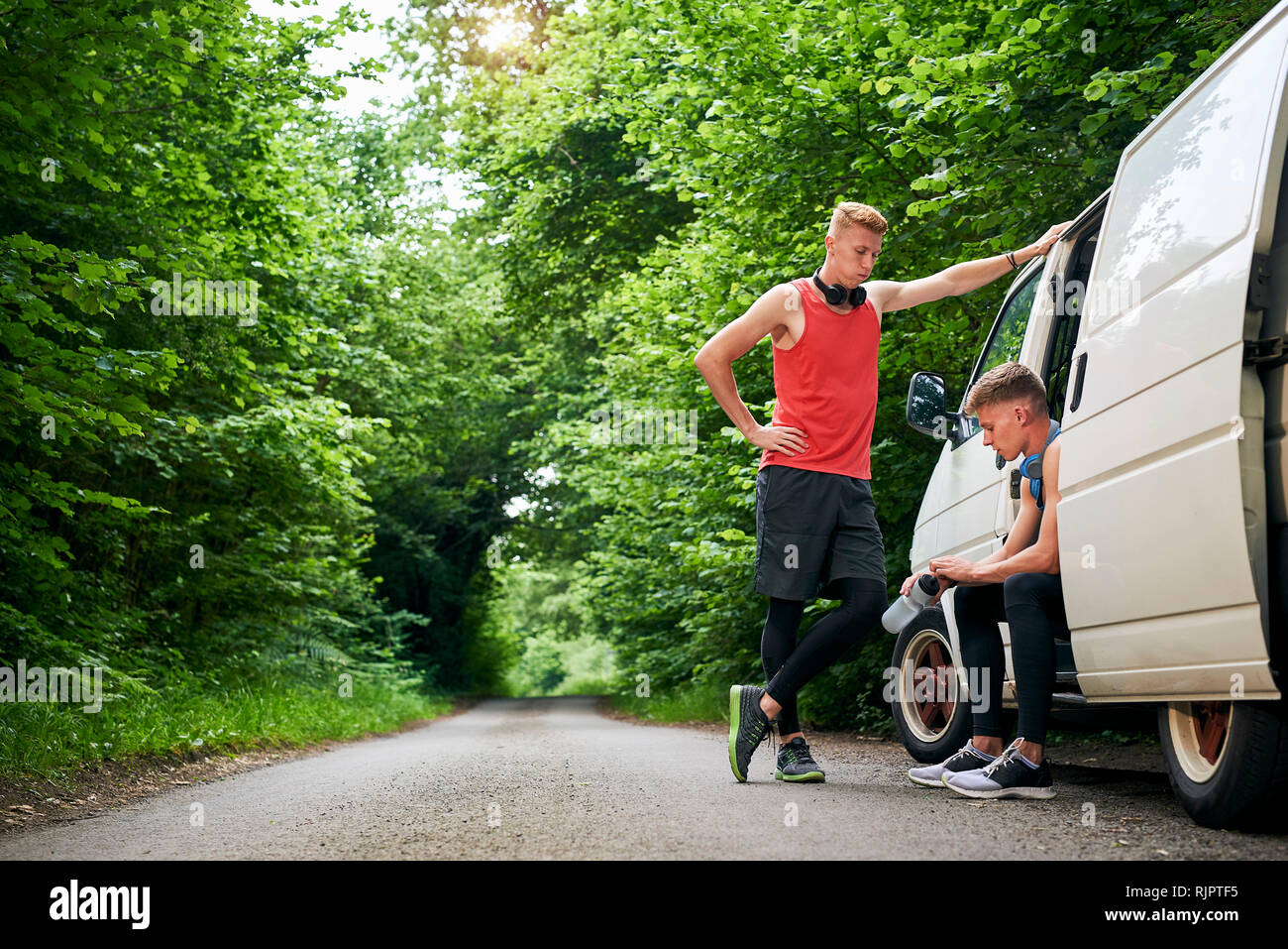 Runner friends talking beside van Stock Photo - Alamy