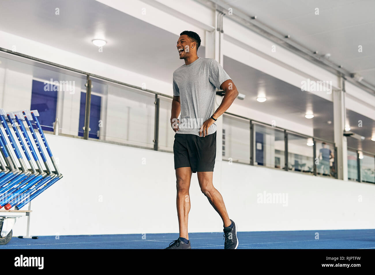 Runner training on indoor running track Stock Photo - Alamy