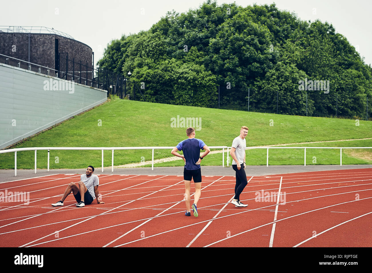 Runners resting on running track Stock Photo - Alamy