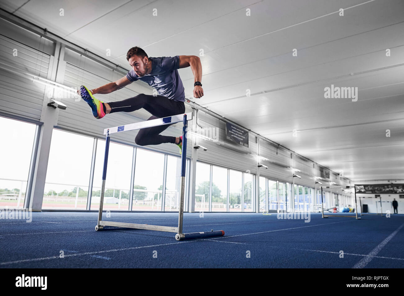 Man jumping hurdle hi-res stock photography and images - Alamy