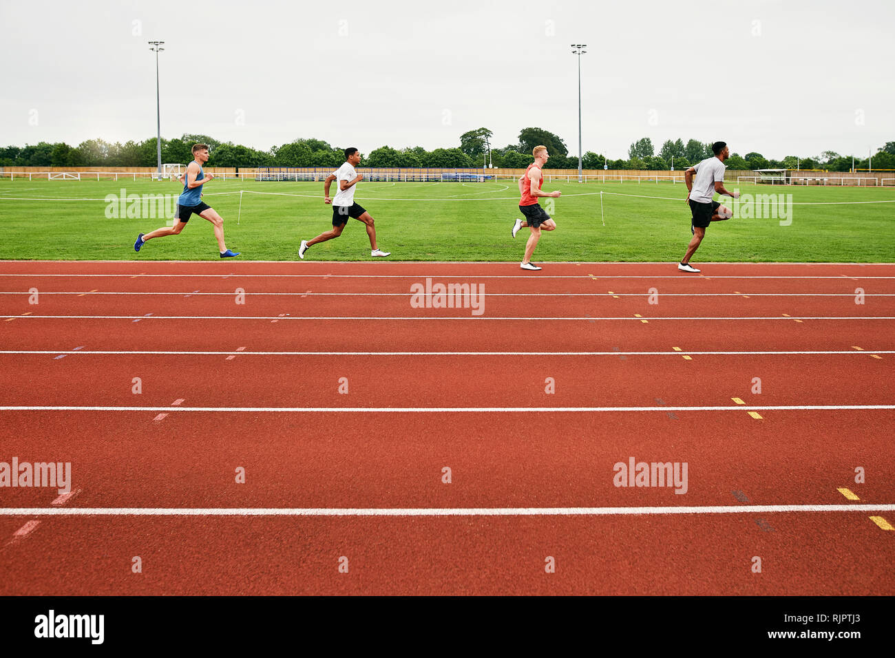 Runners training on running track Stock Photo - Alamy