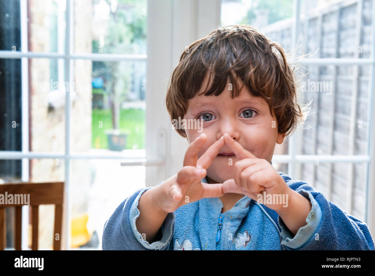 Toddler boy making shapes with his fingers Stock Photo - Alamy