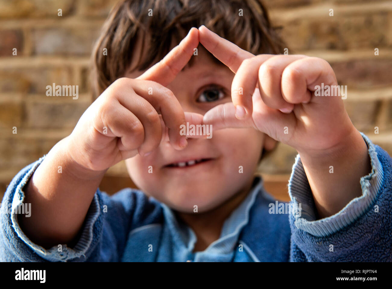 Toddler boy making shapes with his fingers Stock Photo - Alamy