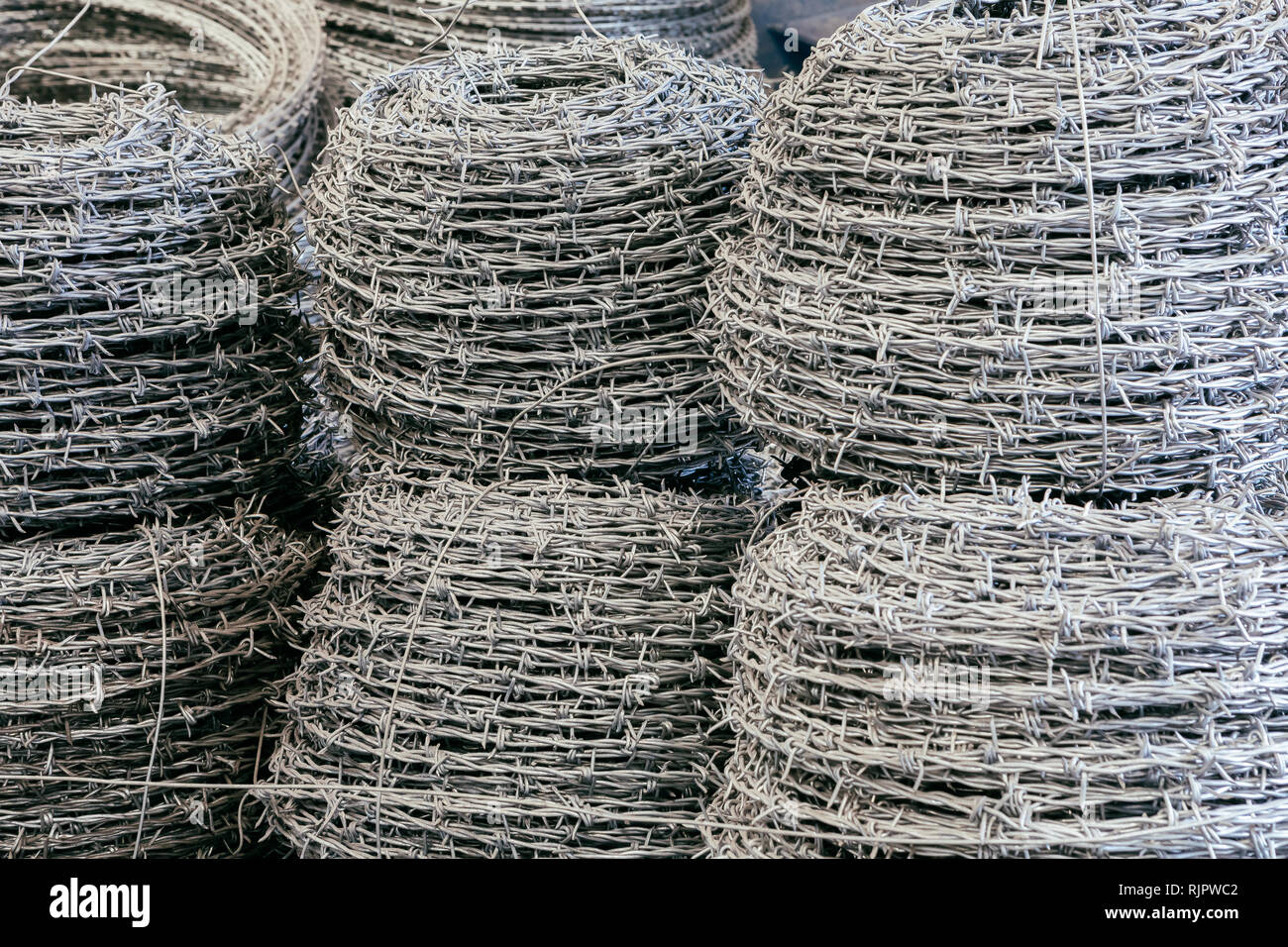 Barbed wire fence safety guard products Stock Photo - Alamy