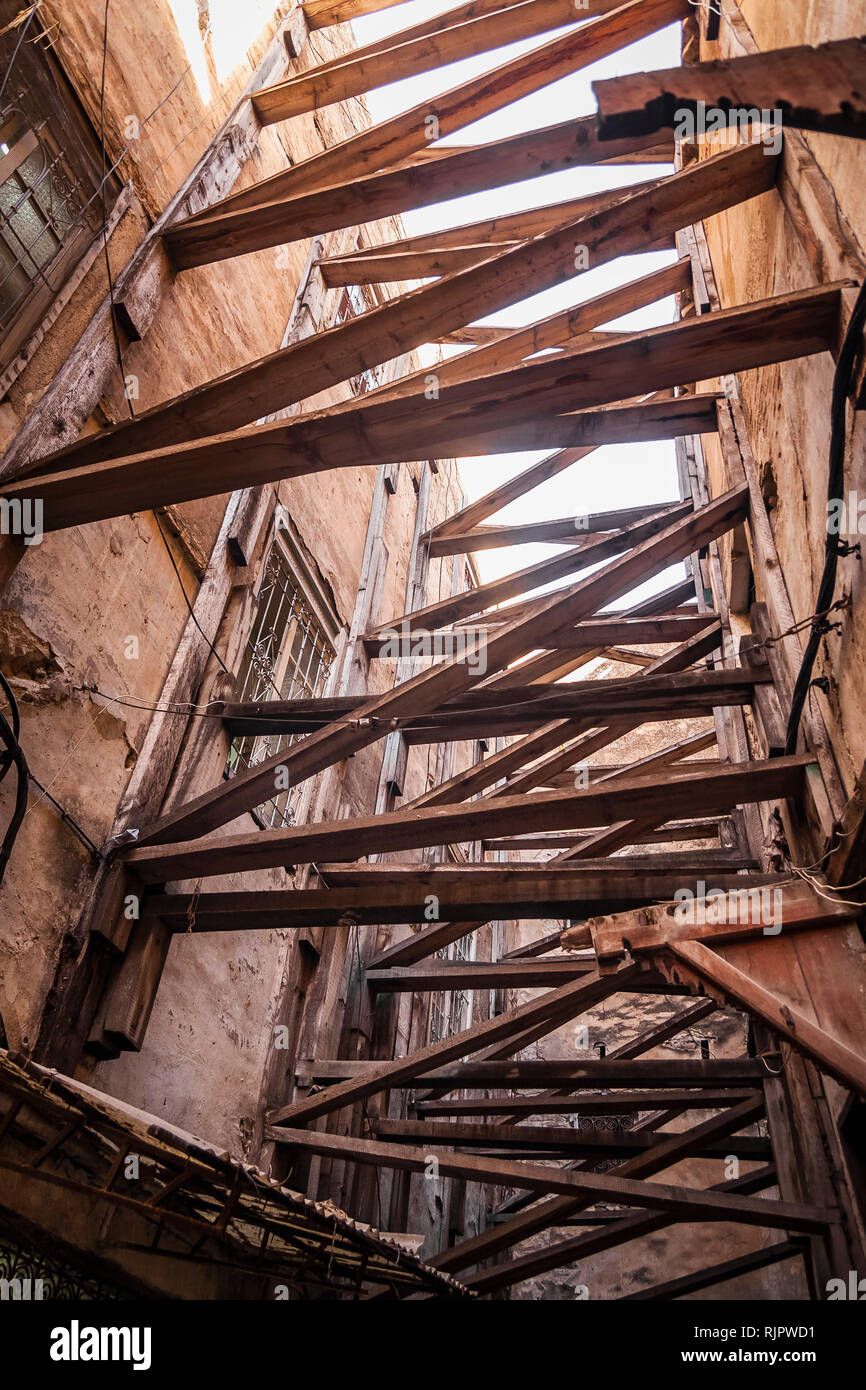 Wooden beams between and supporting buildings, low angle view, Fes ...