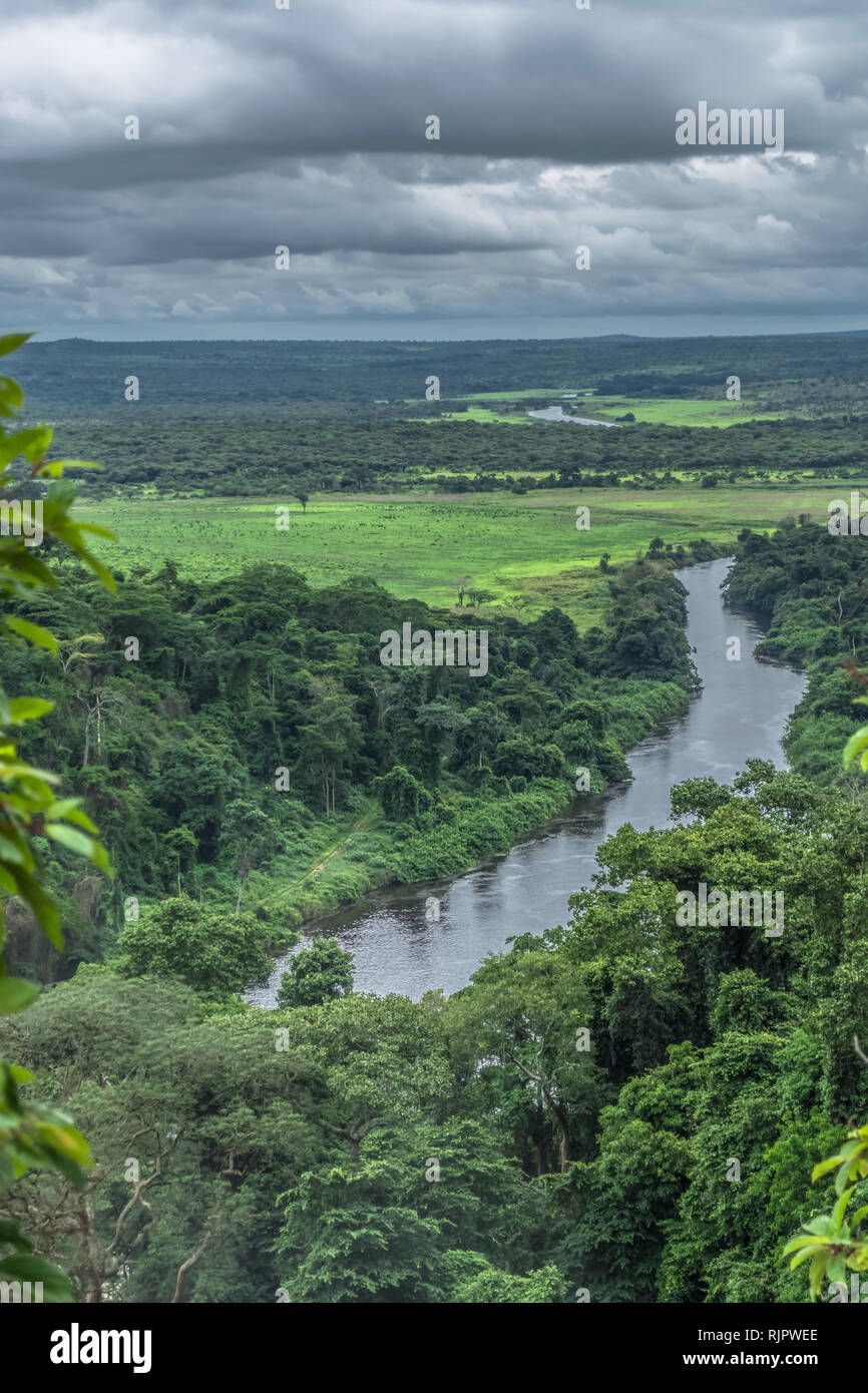 View of the Lucala river, with tropical plains and dramatic sky as ...