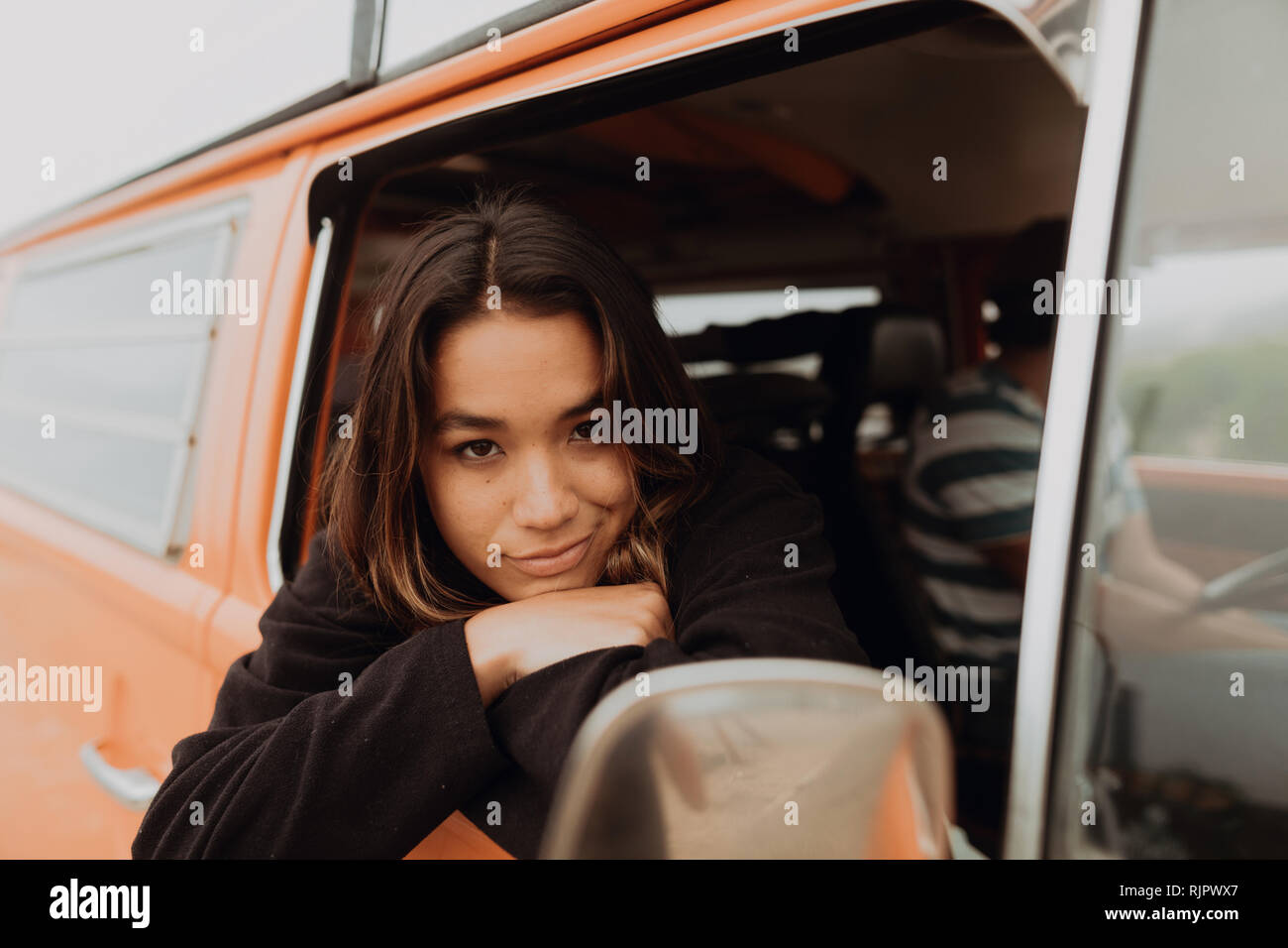 Young woman looking out from recreational vehicle window, portrait ...