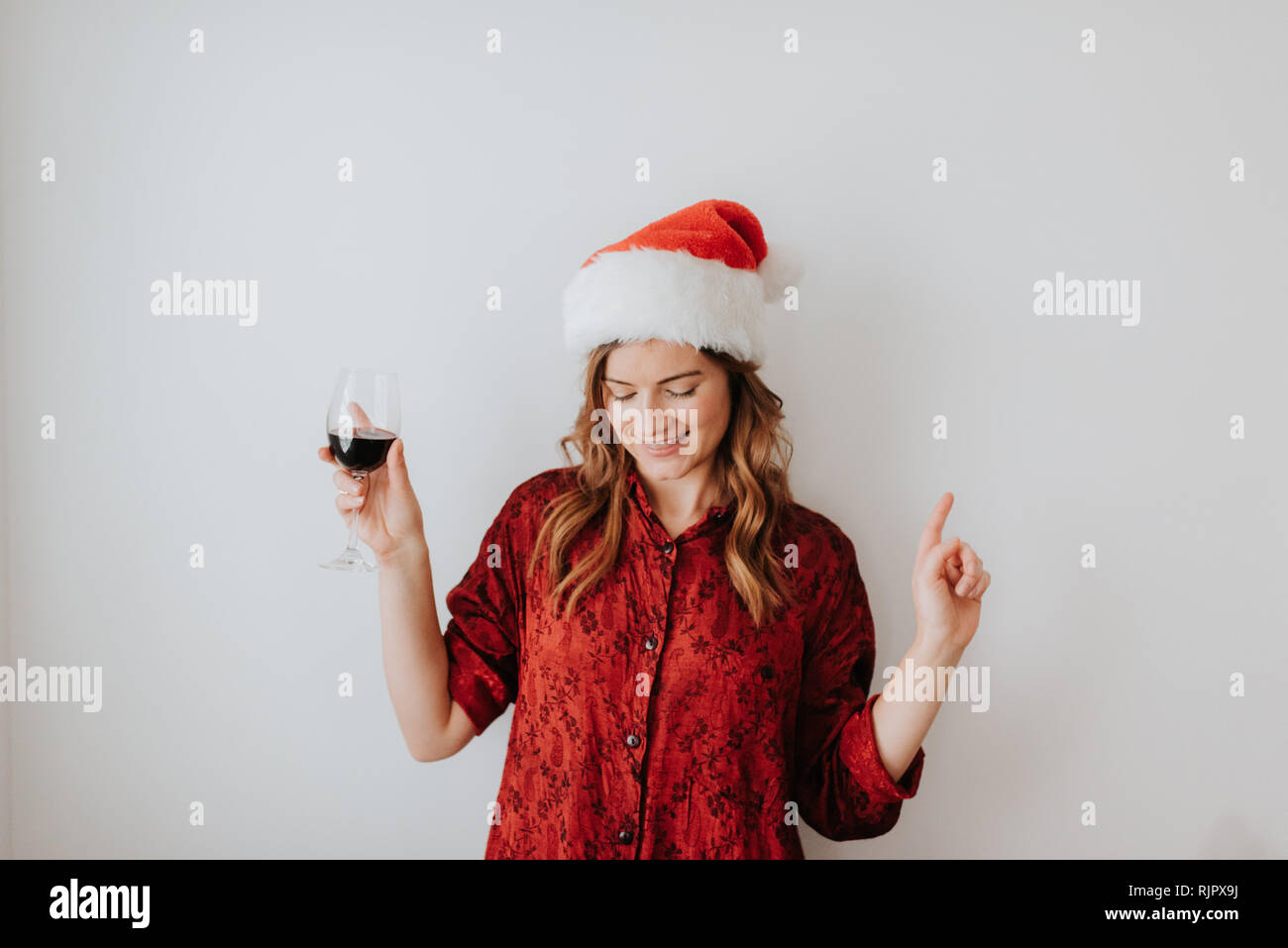 Woman dancing with wine, white background Stock Photo - Alamy