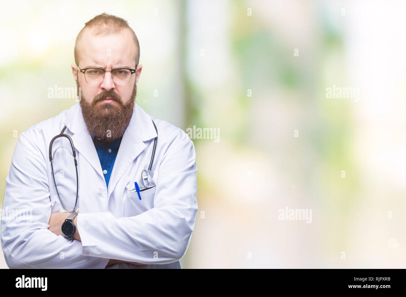 Young caucasian doctor man wearing medical white coat over isolated ...