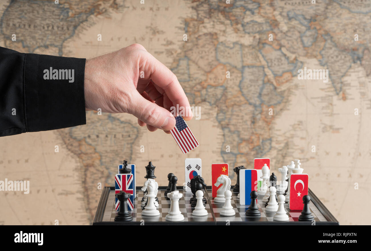 Politician's hand moves a chess piece with a flag. Conceptual photo of ...