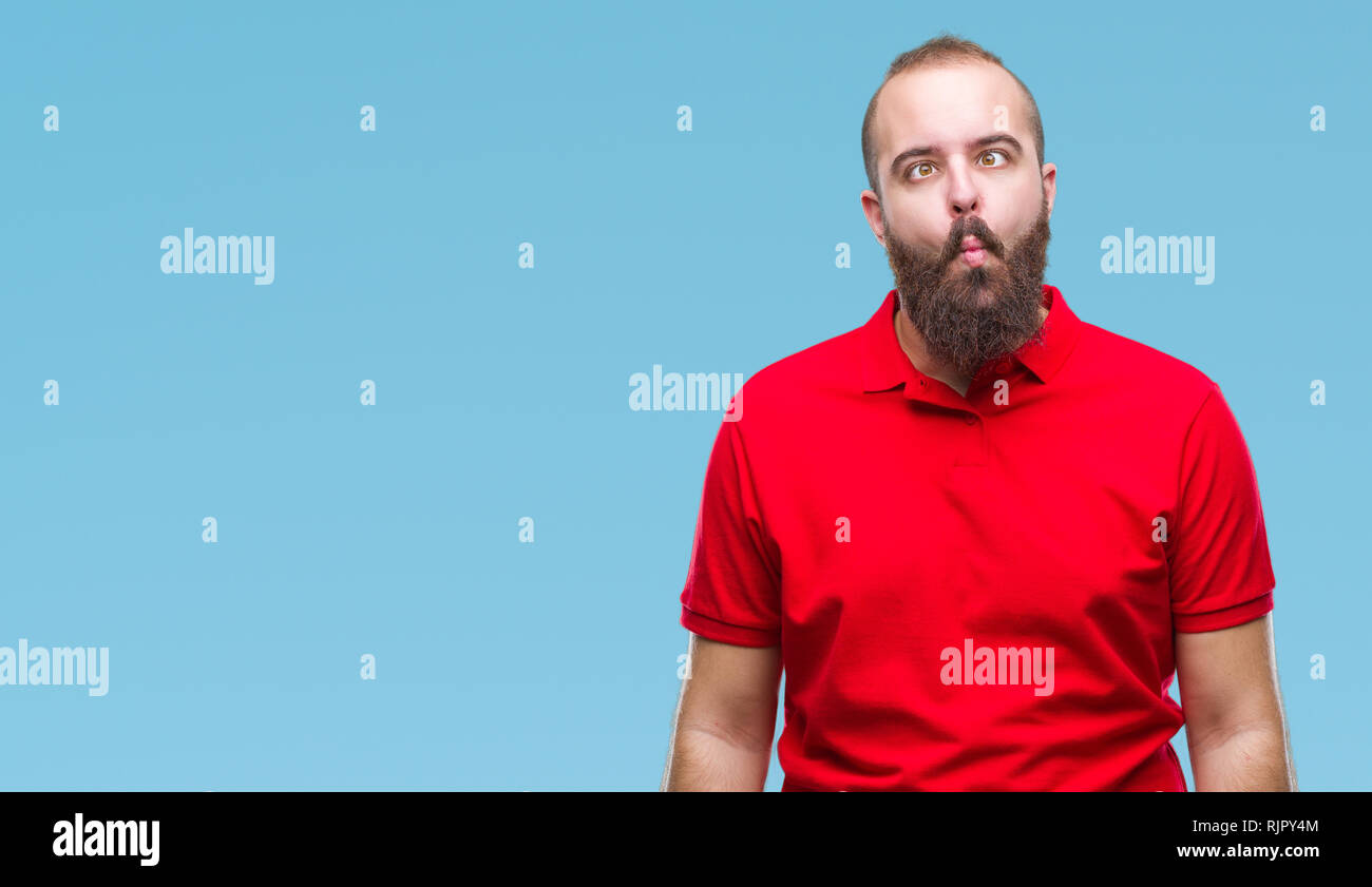 Young caucasian hipster man wearing red shirt over isolated background ...
