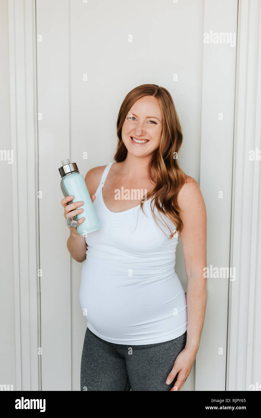 Pregnant woman holding water bottle Stock Photo - Alamy