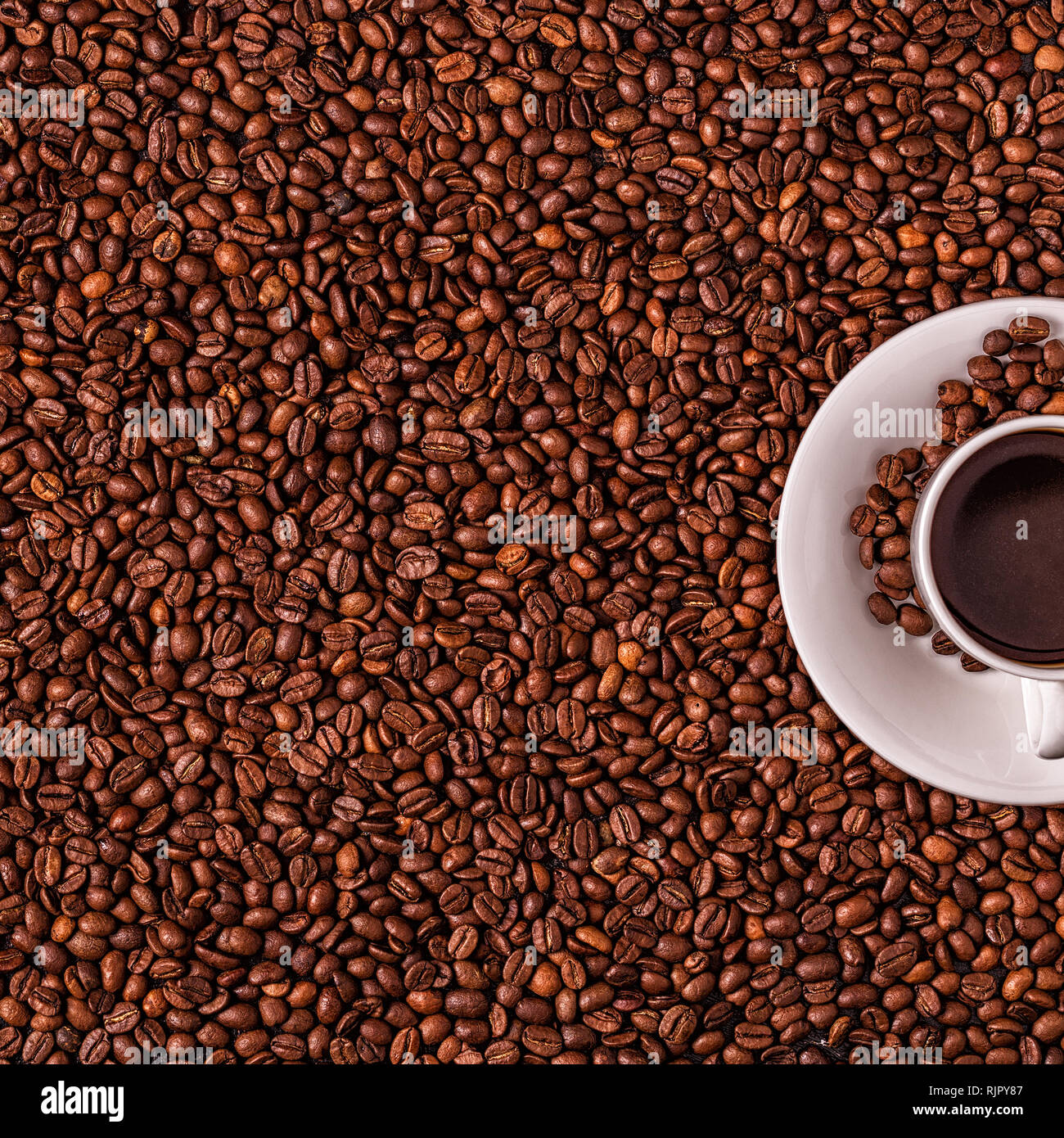 Cup of coffee on a background of coffee beans, top view Stock Photo - Alamy