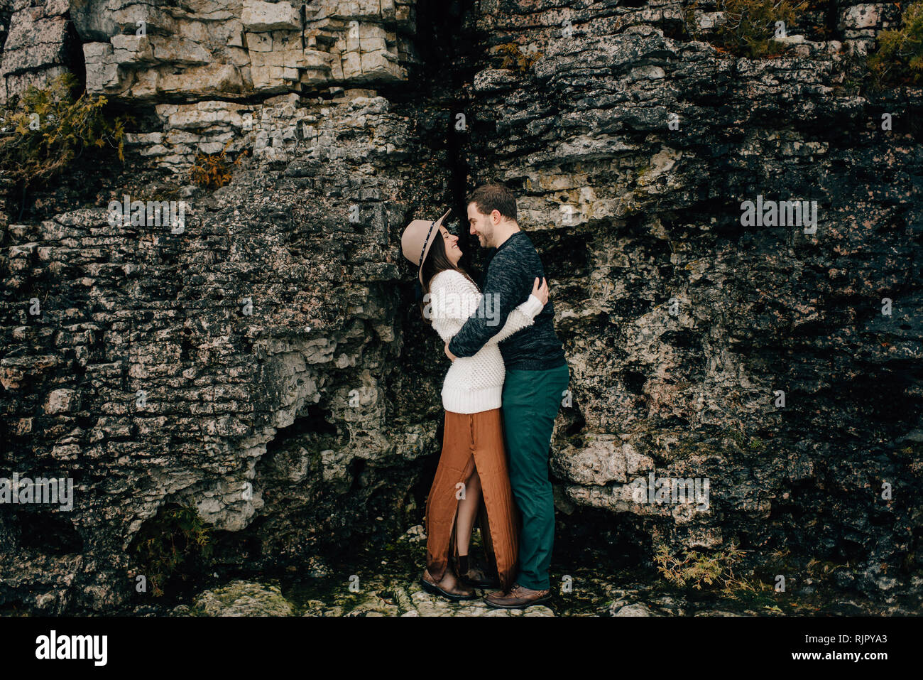 Couple hugging beside rock face, Tobermory, Canada Stock Photo - Alamy