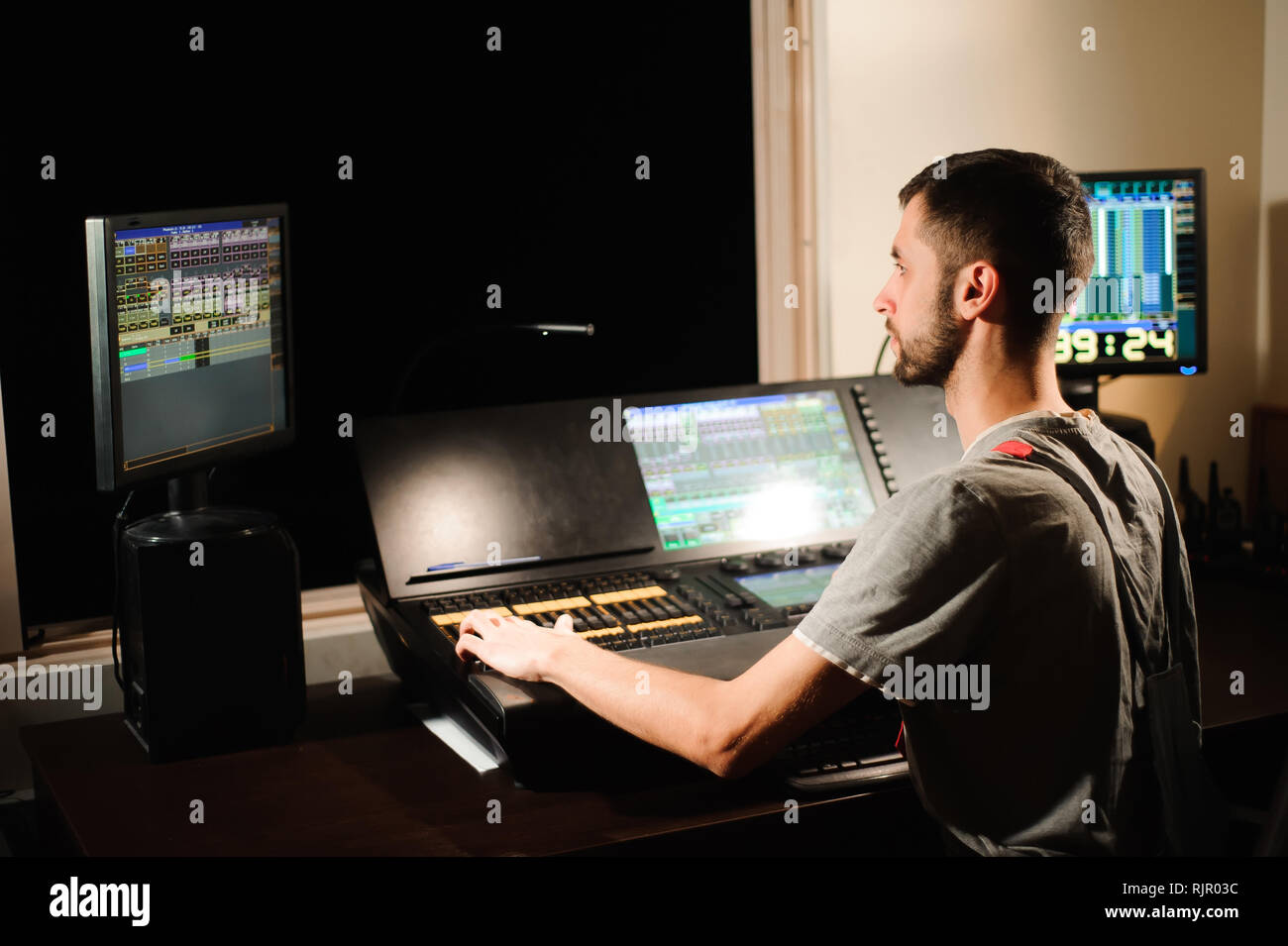 A lighting engineer works with lights technicians control Stock Photo ...