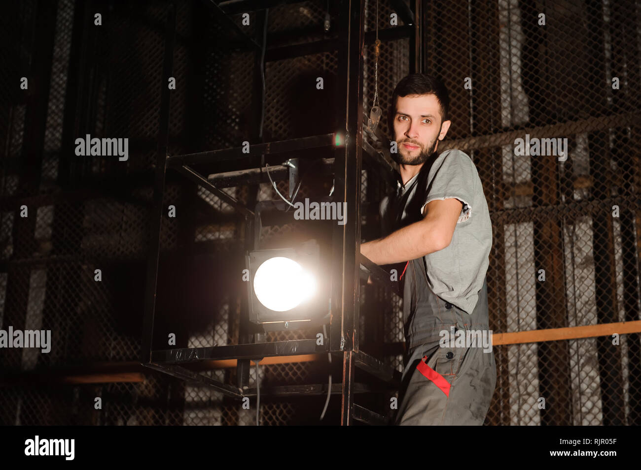 The lighting engineer adjusts the lights on stage near the scenes Stock ...