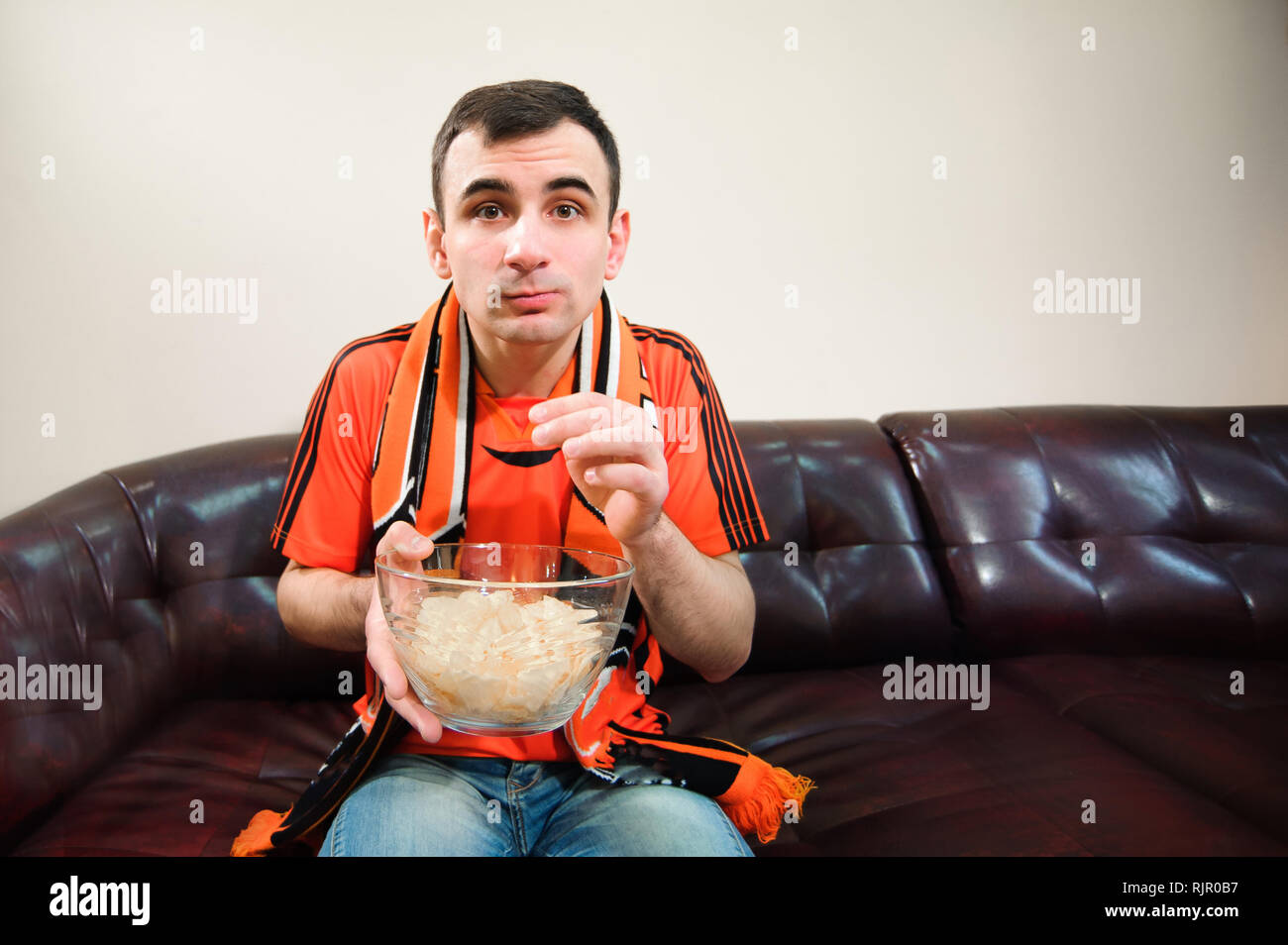 Man watching football, football fan, sports at home Stock Photo - Alamy