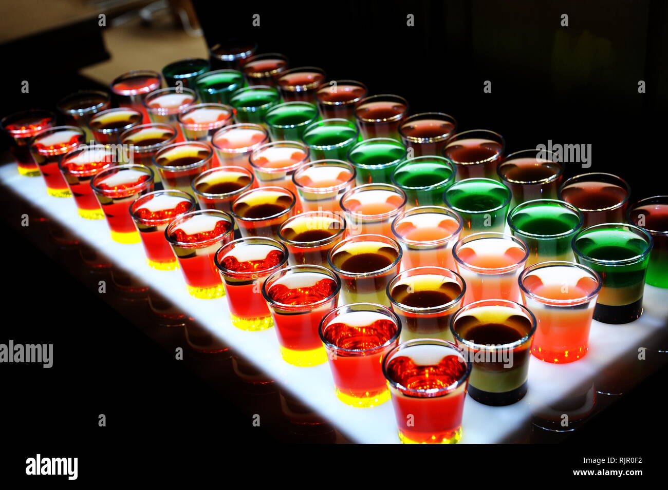 Variation of hard alcoholic shots served on bar counter Stock Photo - Alamy