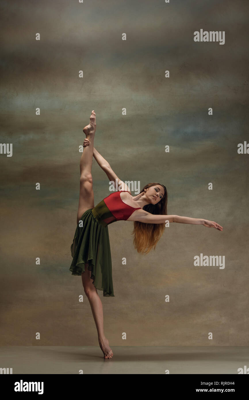 The young woman dancing in contemporary stile on gray background ...