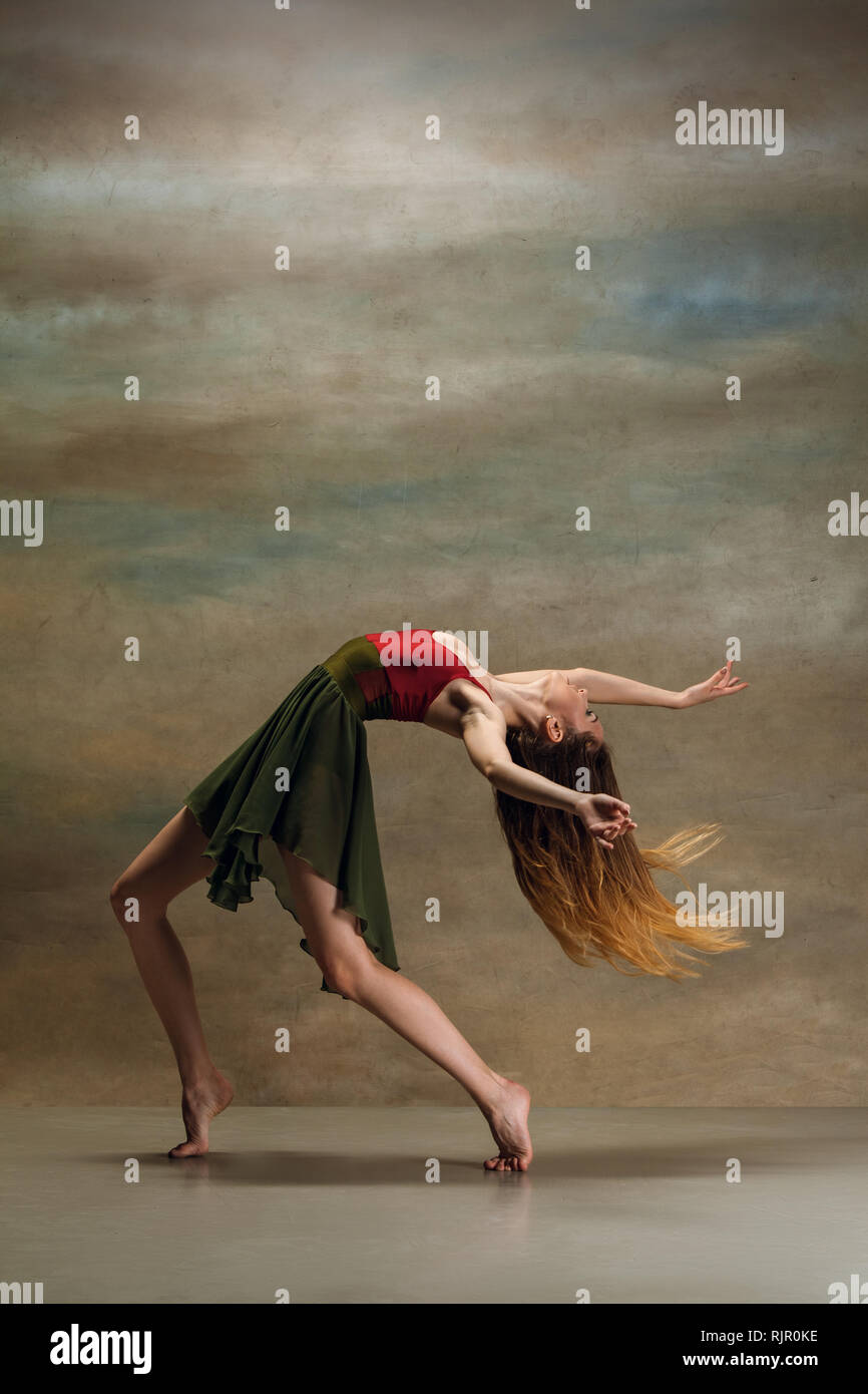 The young woman dancing in contemporary stile on gray background ...