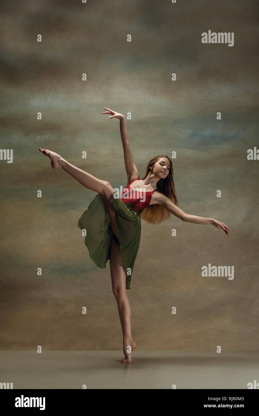 The young woman dancing in contemporary stile on gray background ...