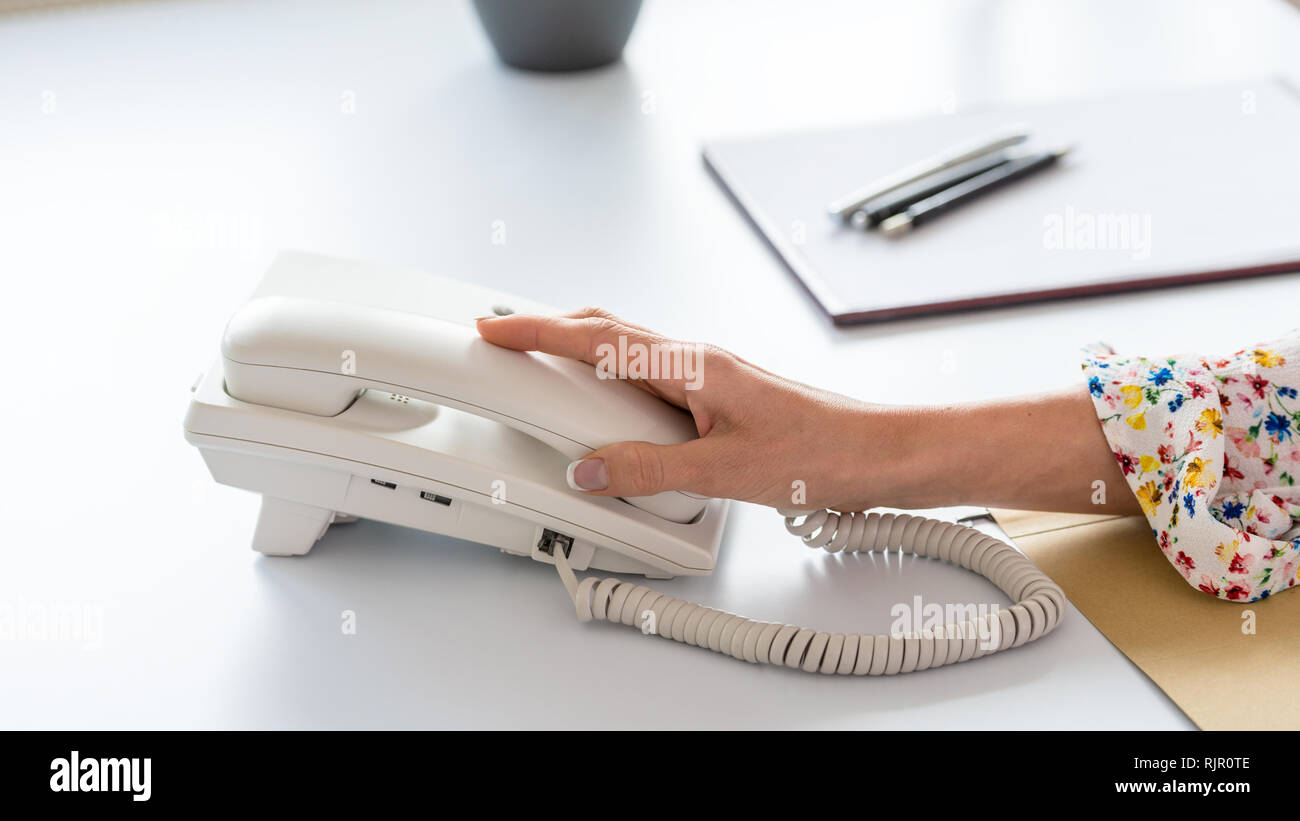 Hand picking up telephone hi-res stock photography and images - Alamy