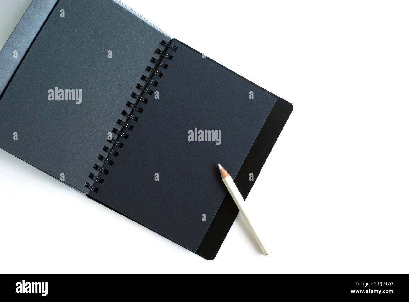 Black paper spiral notebook for write by white pencil Stock Photo - Alamy