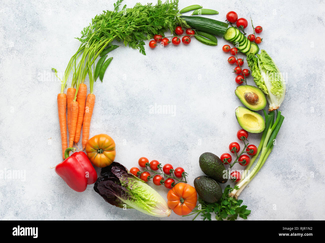 Fresh raw ingredients arranged in a circle on the white table, top view ...