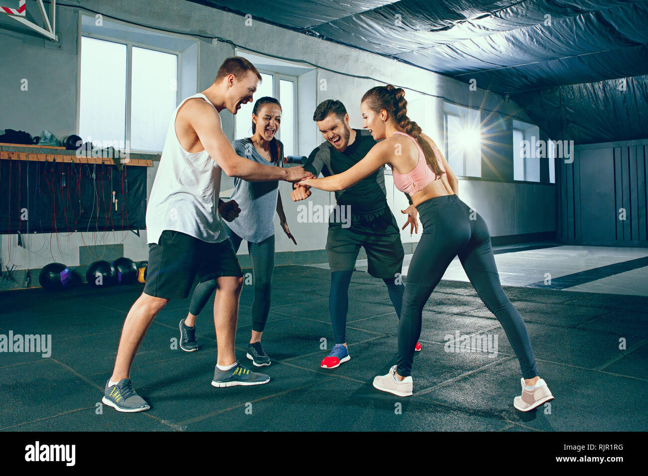 Cropped image of group of sporty muscular people are having rest after ...