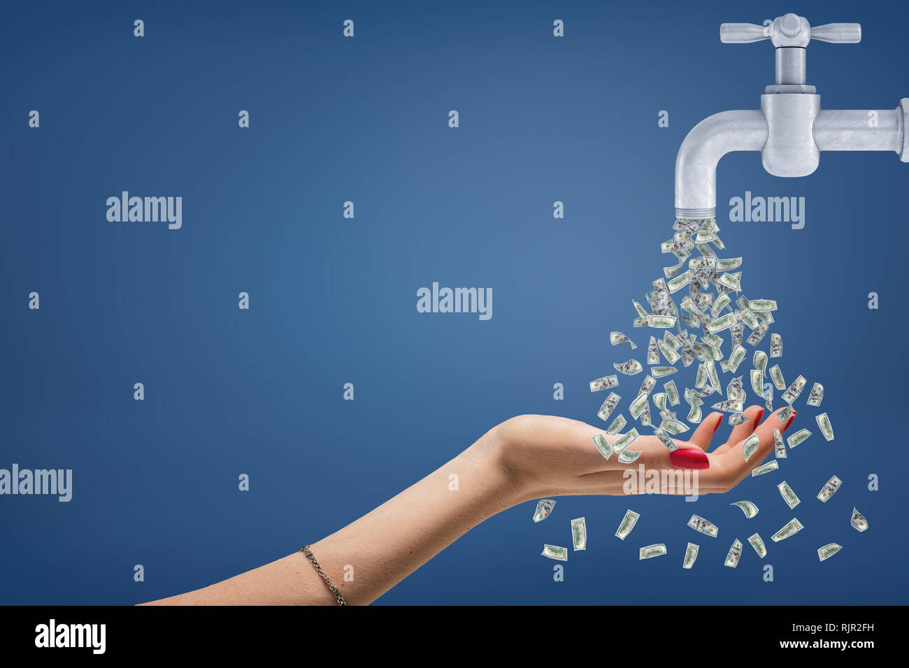 A female hand holds her hand under a stream of money flowing from a ...