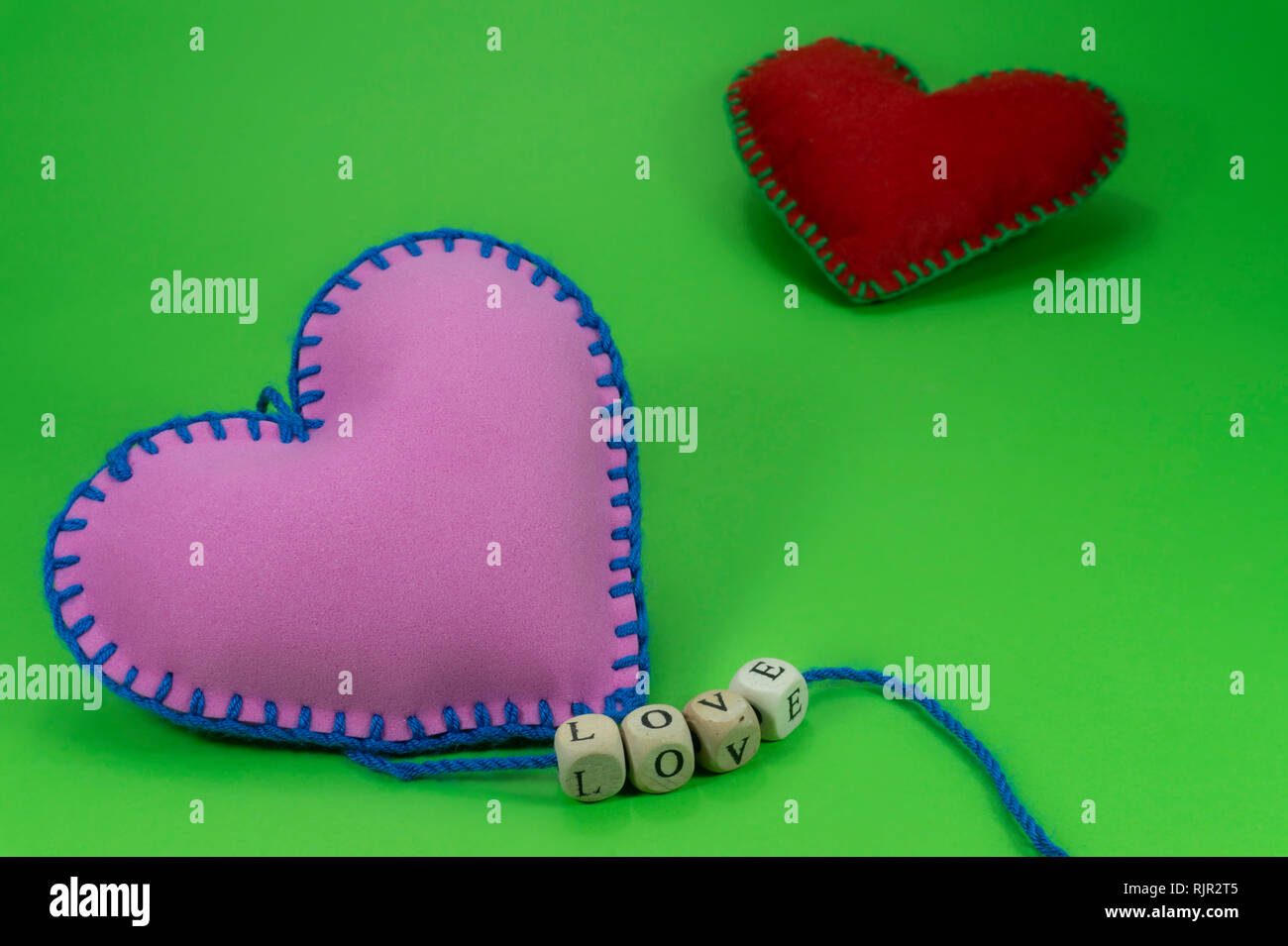 Hand stitched textile hearts with word Love on blocks threaded on ...