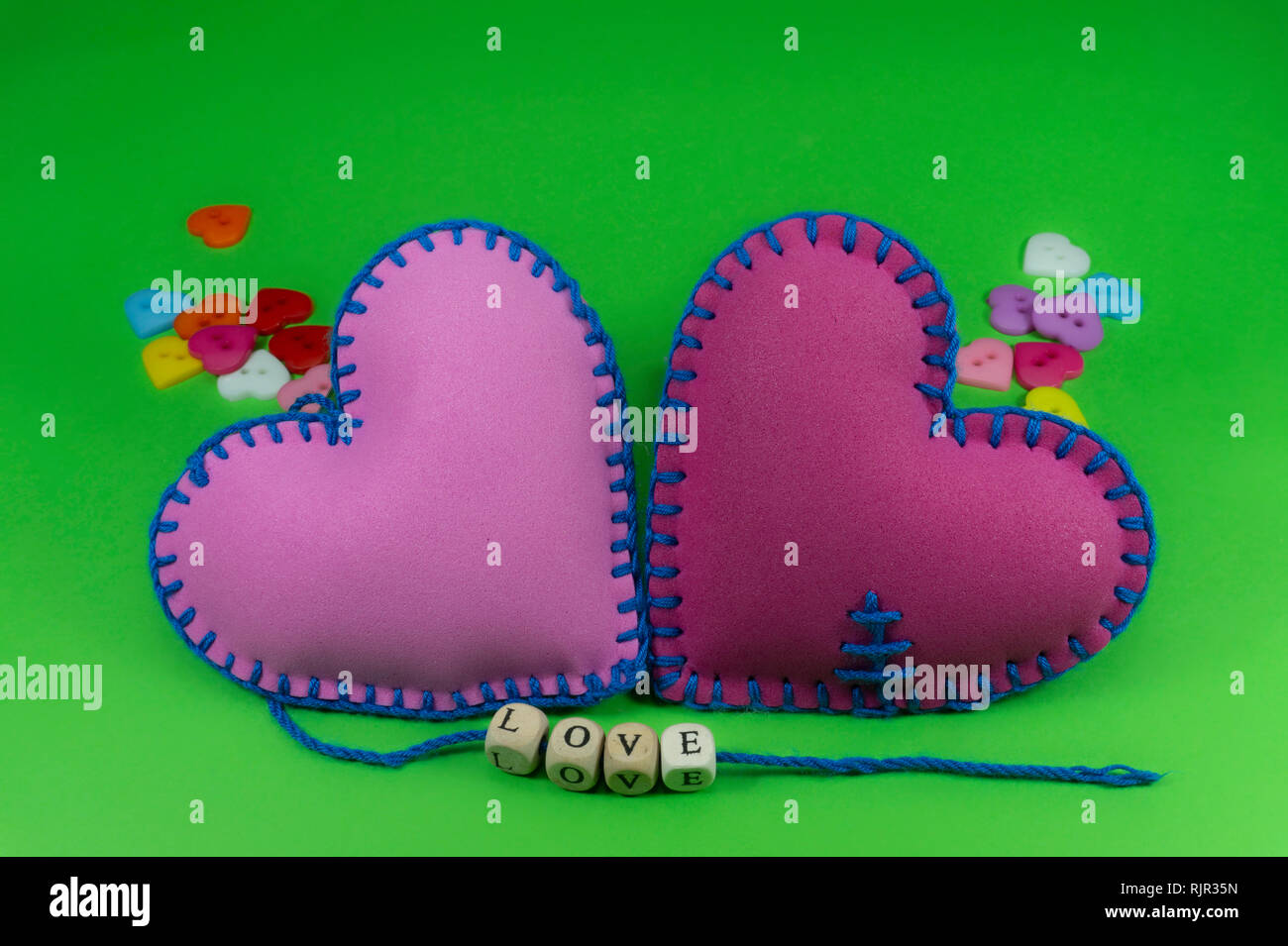 Hand stitched textile hearts with word Love on blocks threaded on ...