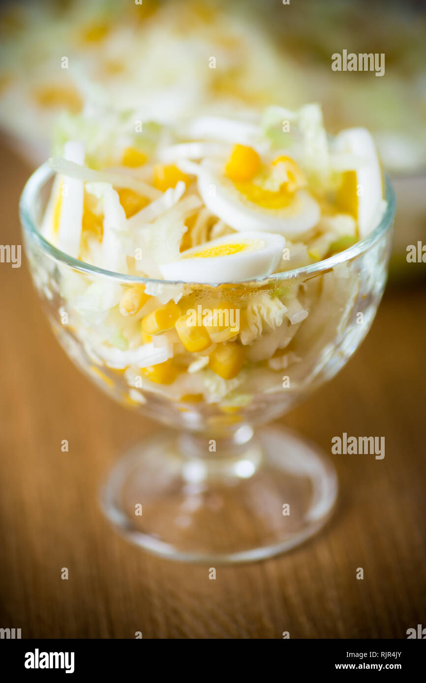 Fresh Peking cabbage salad with boiled eggs, canned corn Stock Photo ...
