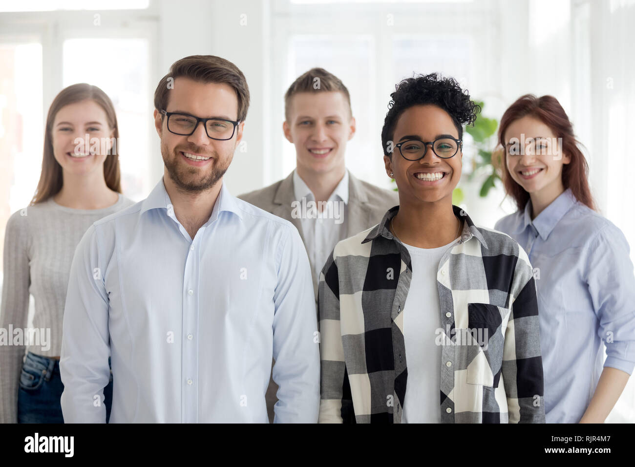 Multiethnic professional leaders and employees looking at camera ...